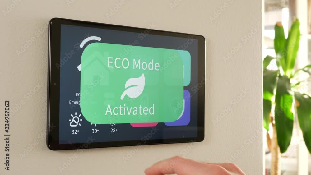 Activating the ECO mode on a smart house control panel. Lowering the ...