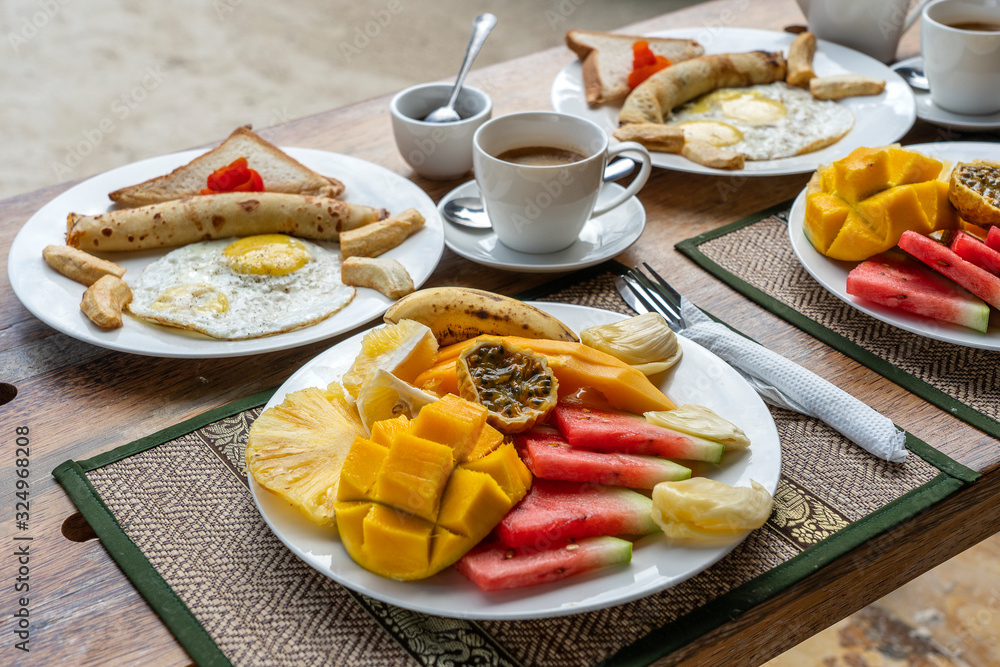 Tropical breakfast of fruit, coffee and scrambled eggs and banana ...