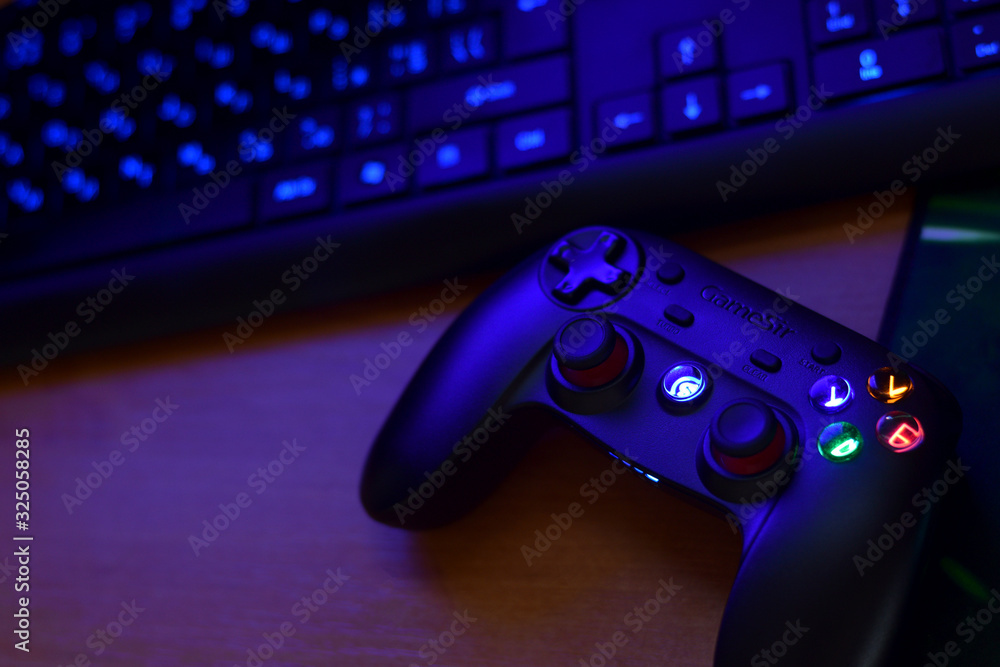 Gamesir g3s video game controller and a4tech keyboard on office table ...