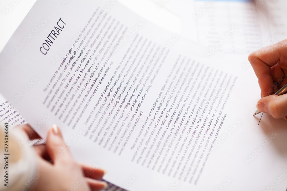 Man signs a contract at a desk in a company office Stock Photo | Adobe ...