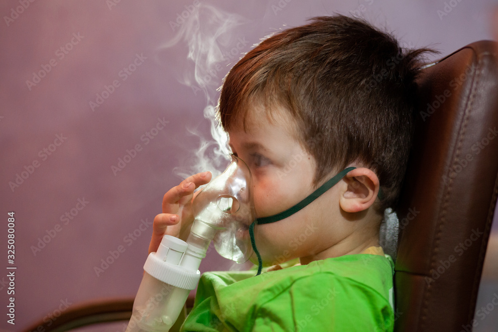 Little boy in a mask, treatments respiratory tract with a nebulizer at ...
