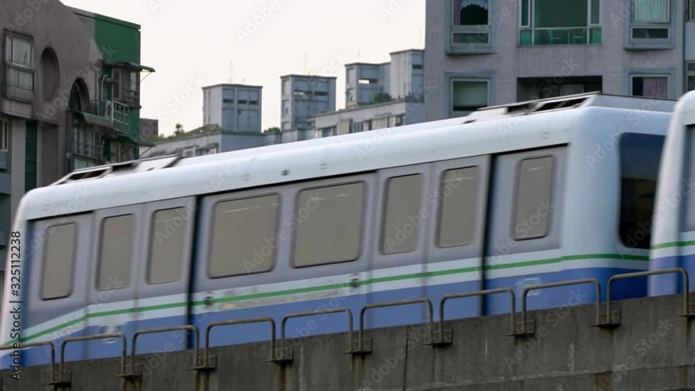 Slow motion of elevated train passing above road. Awesome cityscape ...