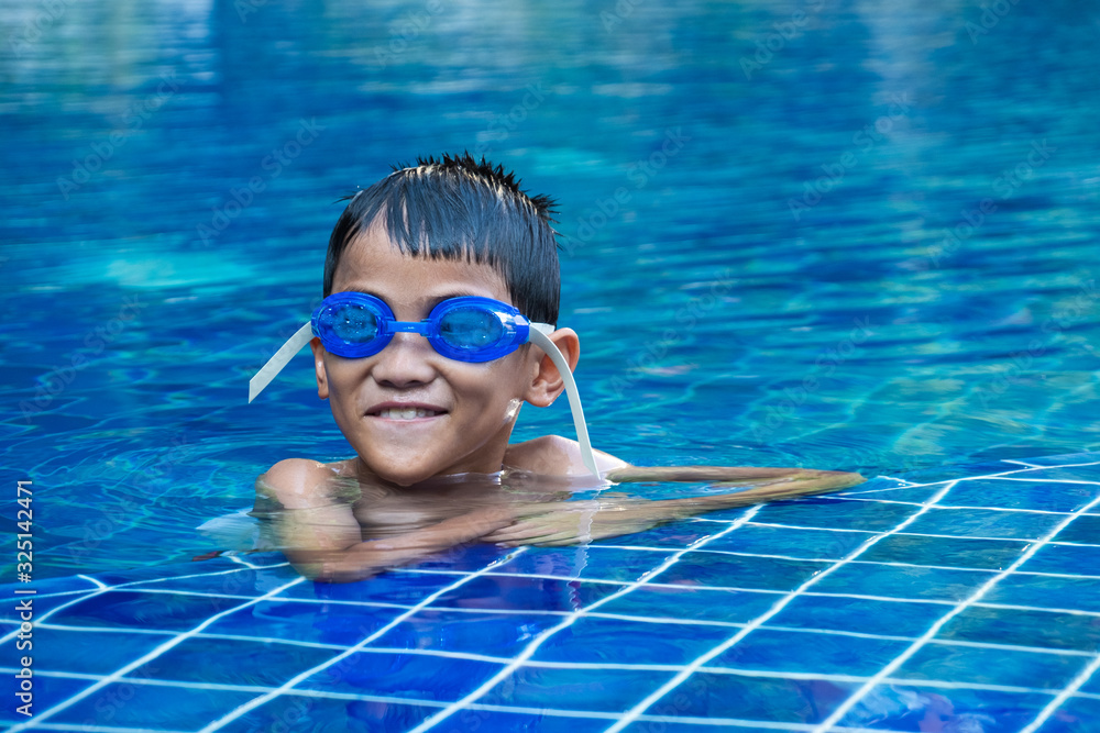Portrait of asian boy ware a blue glasses and floating at the corner of ...