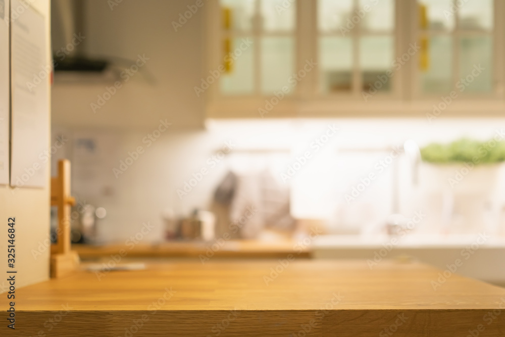Wood table with blur kitchen room background .For montage product ...