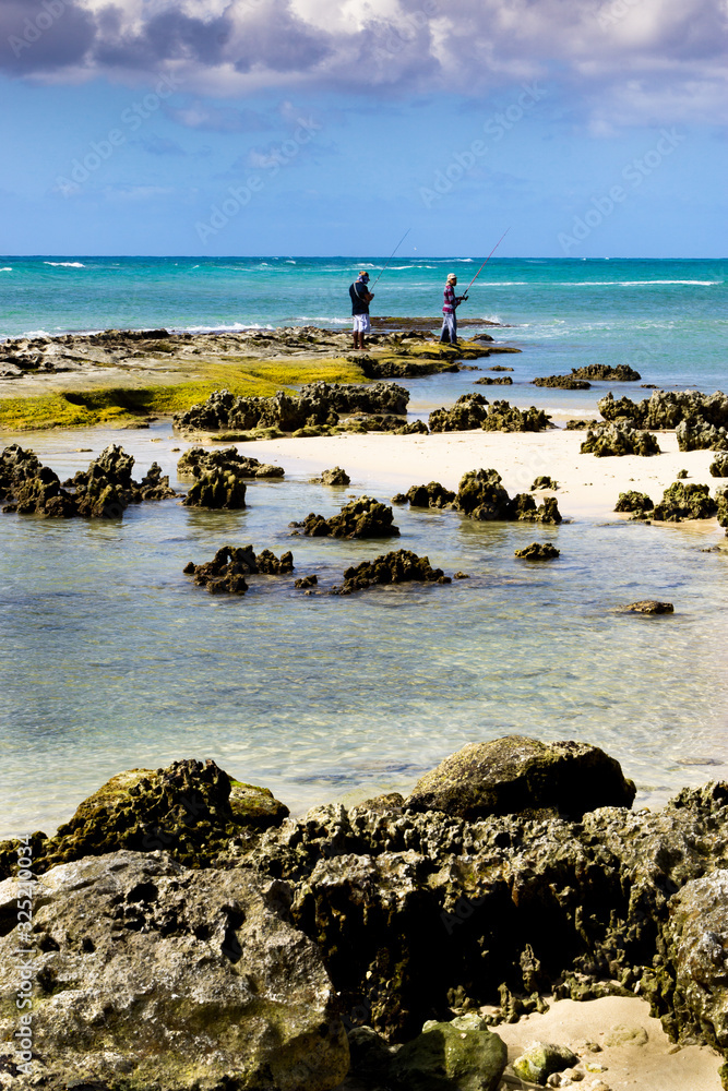 Lonely fishermen on a rocky lava-formed Hawaiian beach called ...