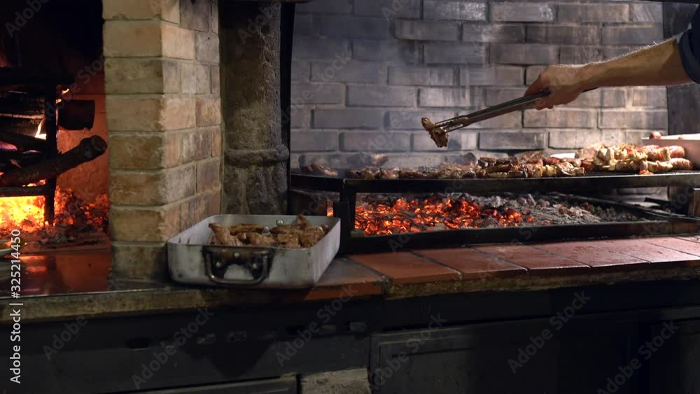 Old traditional italian technique of roasting sliced meat on barbecue ...