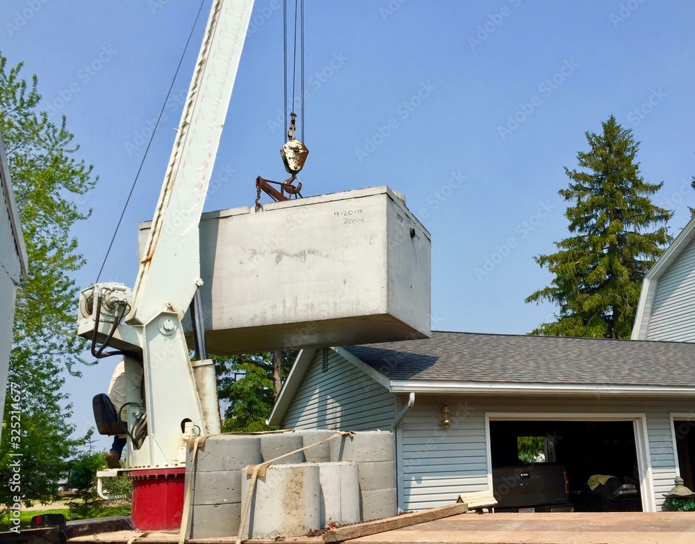 Septic tanks lifted by a crane Stock Photo | Adobe Stock