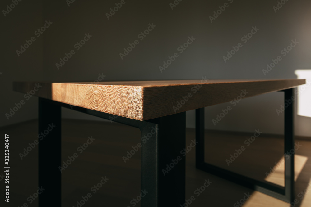 Detailed texture of modern wooden table and angular iron structures in ...