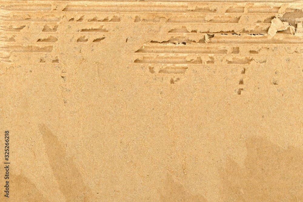 ripped damaged corrugated cardboard background, shredded brown paper ...