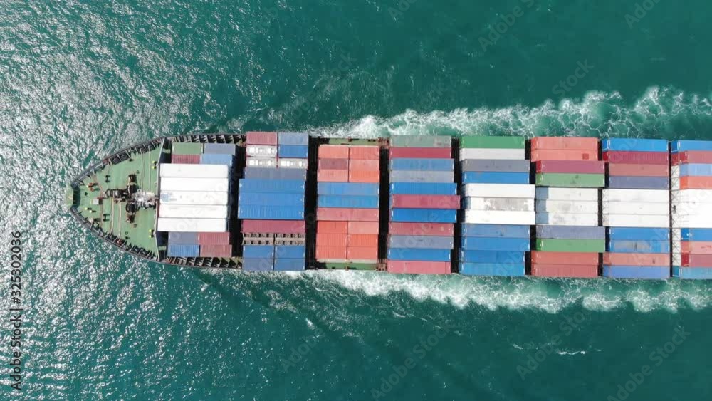 Aerial of cargo ship carrying container and running verry fast for ...
