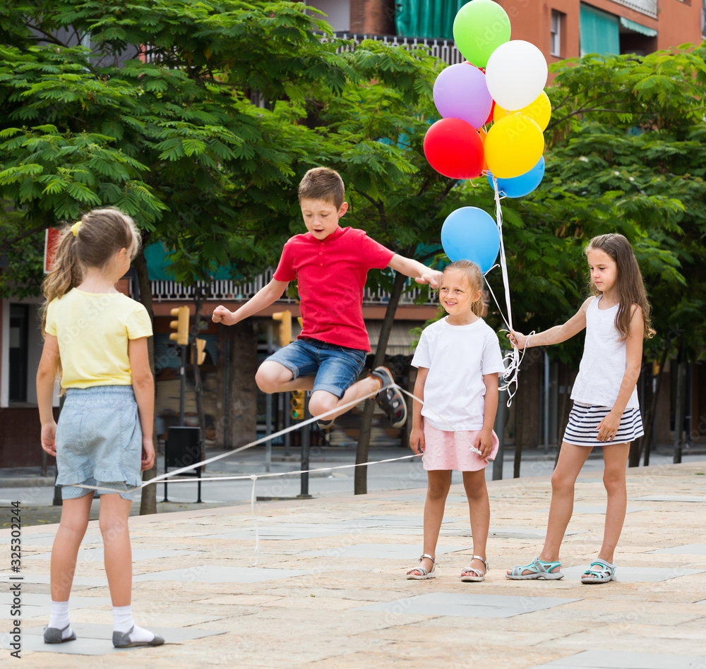 Laughing kids playing with chinese jumping rope Stock Photo | Adobe Stock