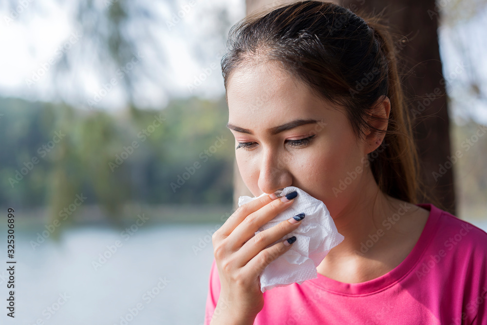 Asian woman sick with paper napkin blowing nose, Common cold. Upper ...