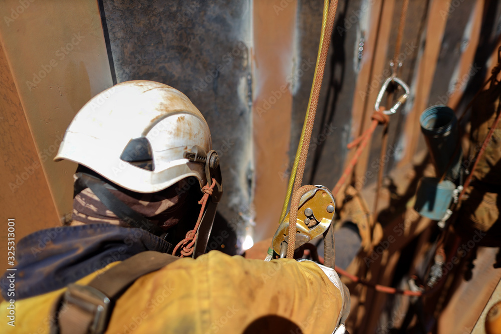 Safe work practices rope access industrial maintenance welder wearing ...