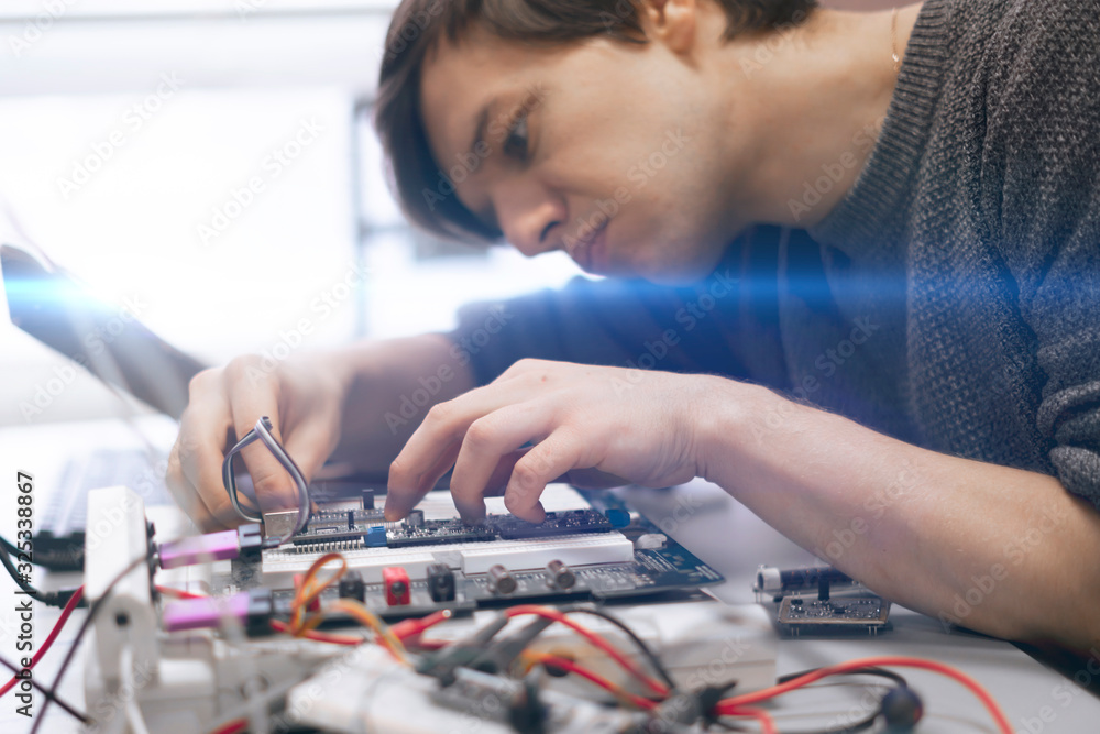 student making measurement and costruct the circuit board with engineer ...