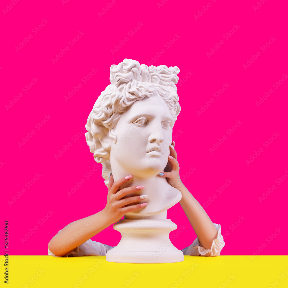 Statue on a pink background. Gypsum statue of Apollo head. Man ...
