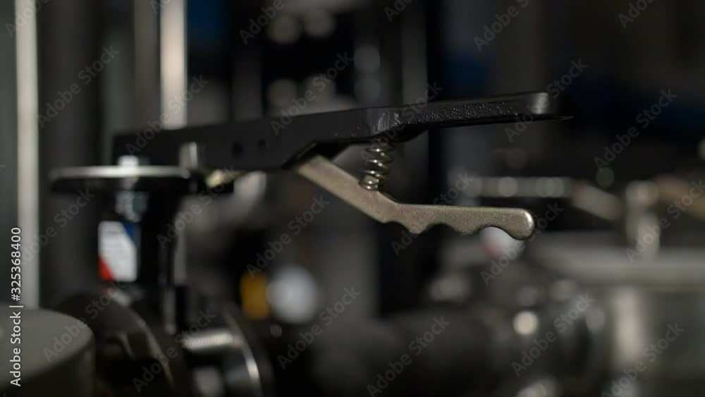 Engaging Industrial Lever Valve with Hand On Steel Machine To turn it ...