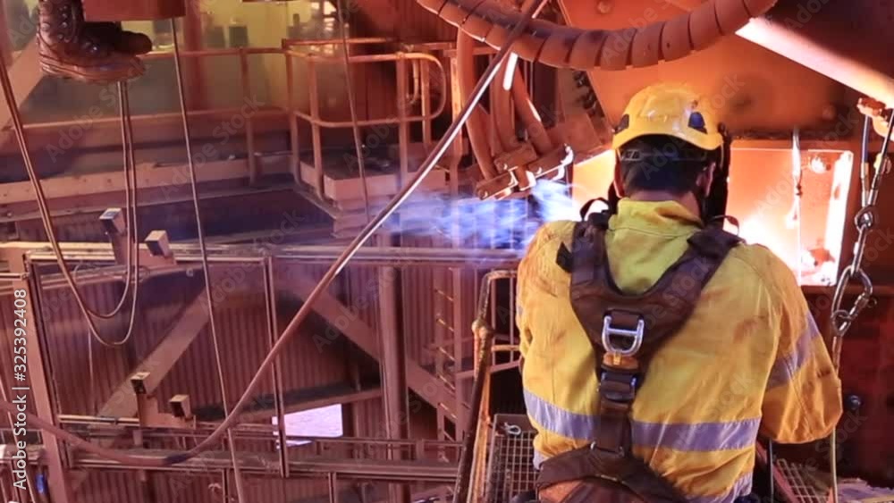 Footage of rope access welder wearing safety equipment, glove ...