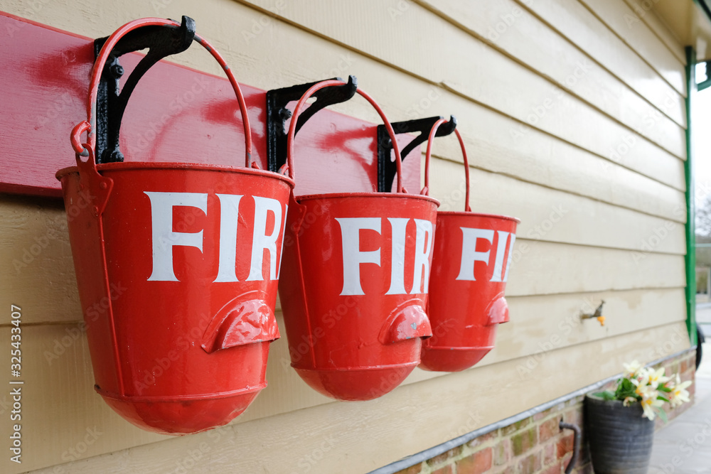 Trio of vintage style Fire Buckets seen hanging outside a timber built ...