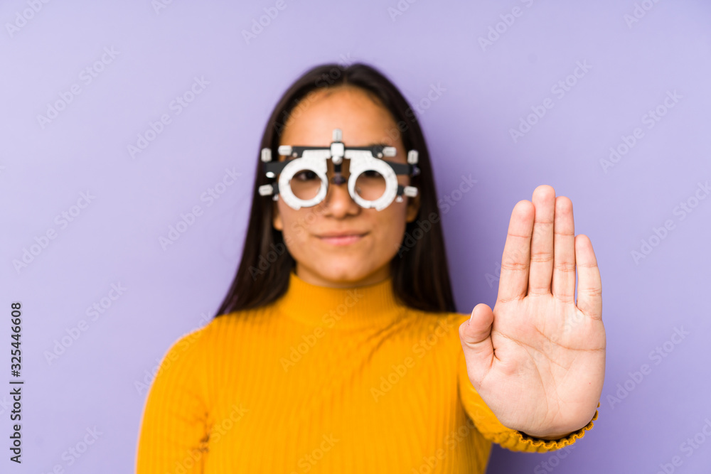 Youn indian woman with optometry glasses standing with outstretched ...