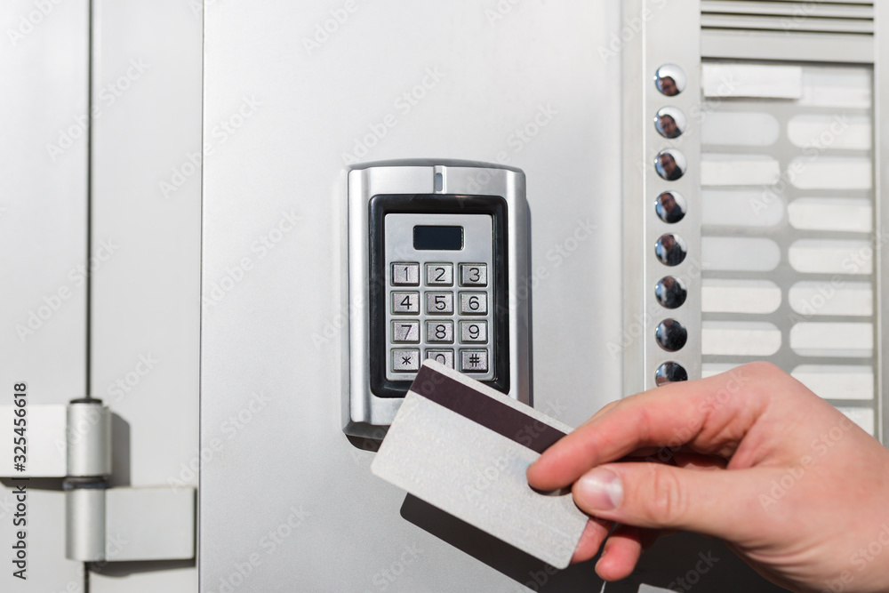 Man hand holding and scanning security key card on electric lock to ...