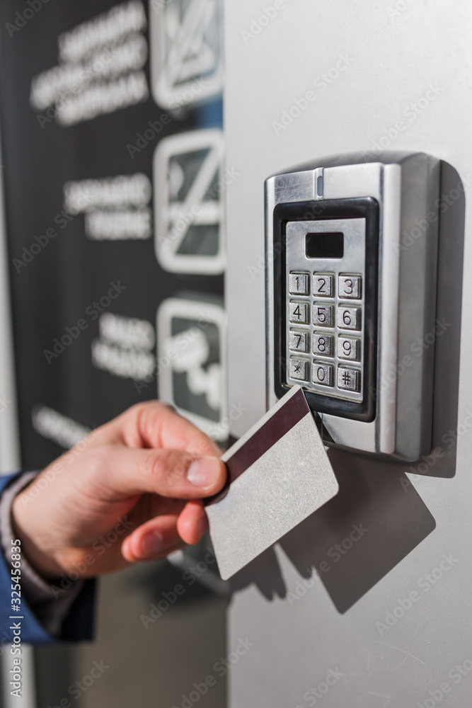 Man scanning security key card on electric lock to entry private ...