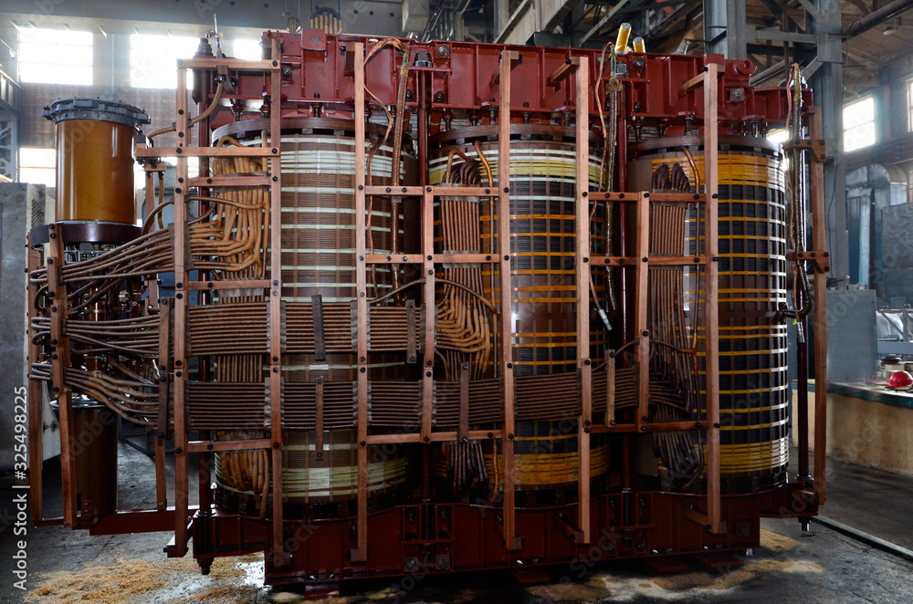 High-voltage three-phase transformer during overhaul at the factory ...