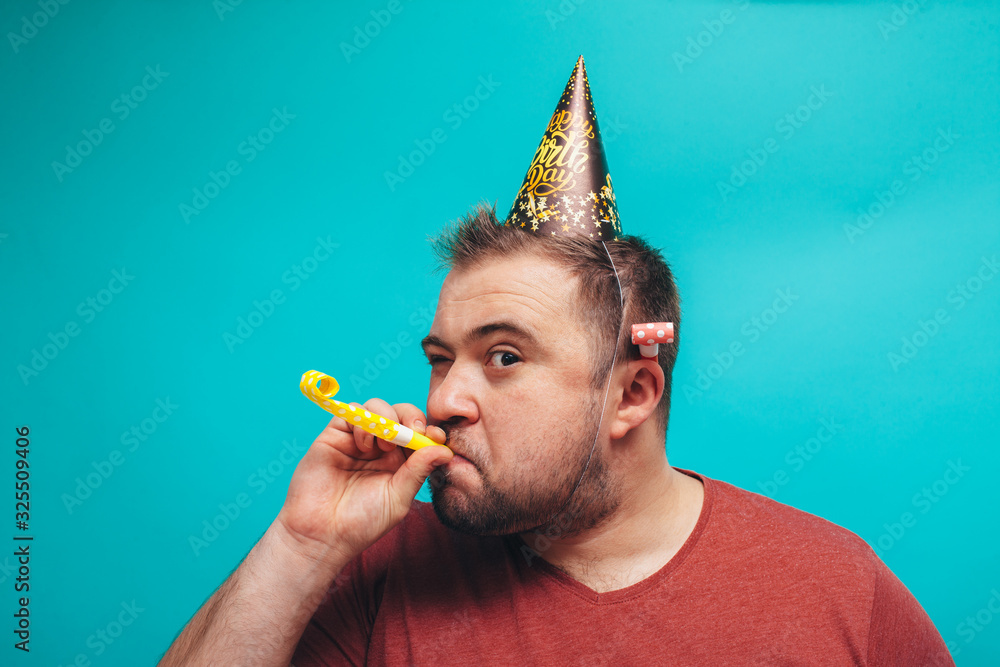 Funny portrait of fat man who is celebrating his birthday, wearing ...