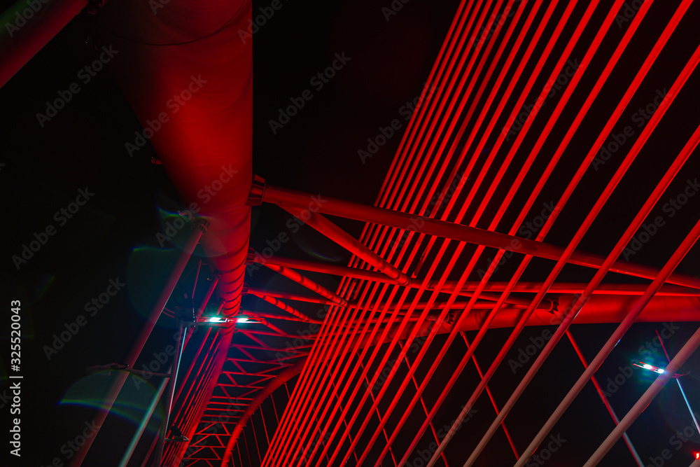 The illuminated structure of the Seri Saujana Bridge at night. One of ...