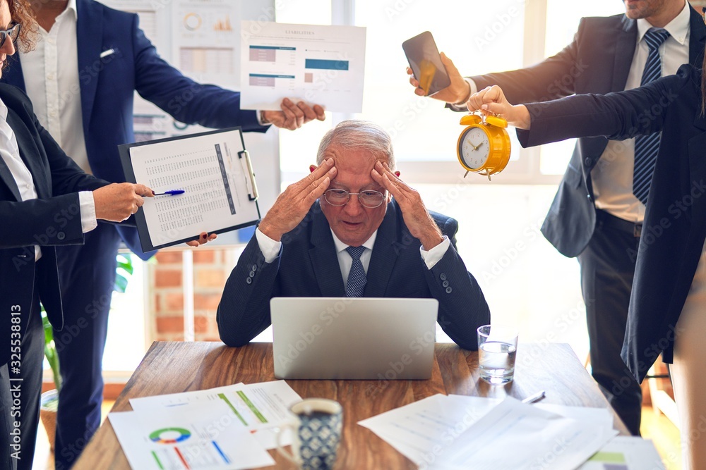 Group of business workers working together in a meeting. One of them ...