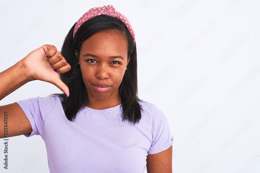 Beautiful young african american woman wearing a diadem over isolated ...