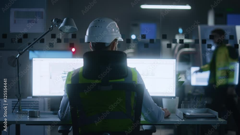 Industrial Engineer Solving Problems, Working on a Personal Computer ...