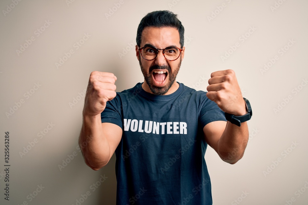 Handsome man with beard wearing t-shirt with volunteer message over ...