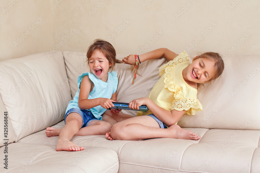 Two little mad angry girls sisters having fight at home. Friends girls ...