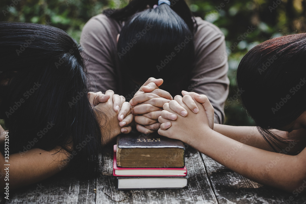 Group of different women praying together Stock Photo | Adobe Stock