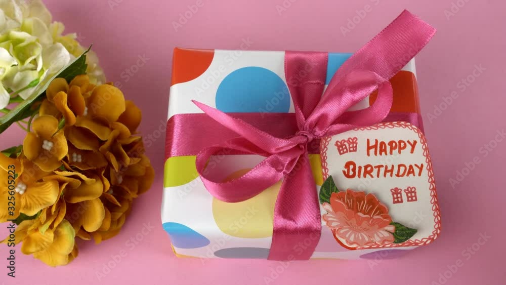 Video Stock Top view shot of beautiful flowers and a colorful birthday ...