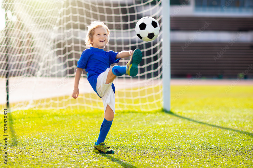Kids play football. Child at soccer field. Stock Photo | Adobe Stock