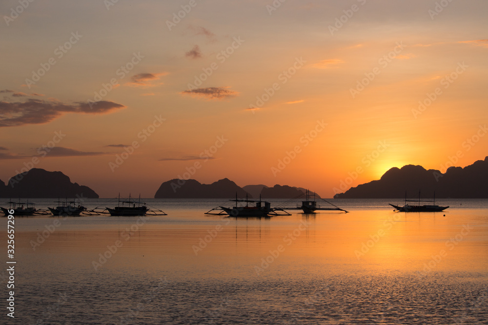 Beautiful calm sunset in Philippines, Palawan. Boats at sea with ...