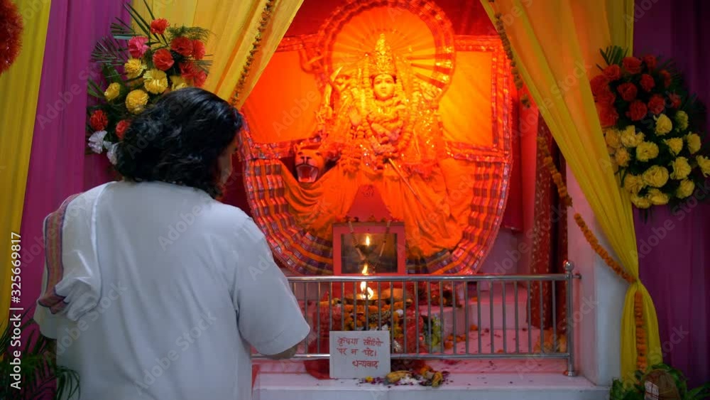 Indian priest worshipping in the temple/mandir of Goddess Durga ...