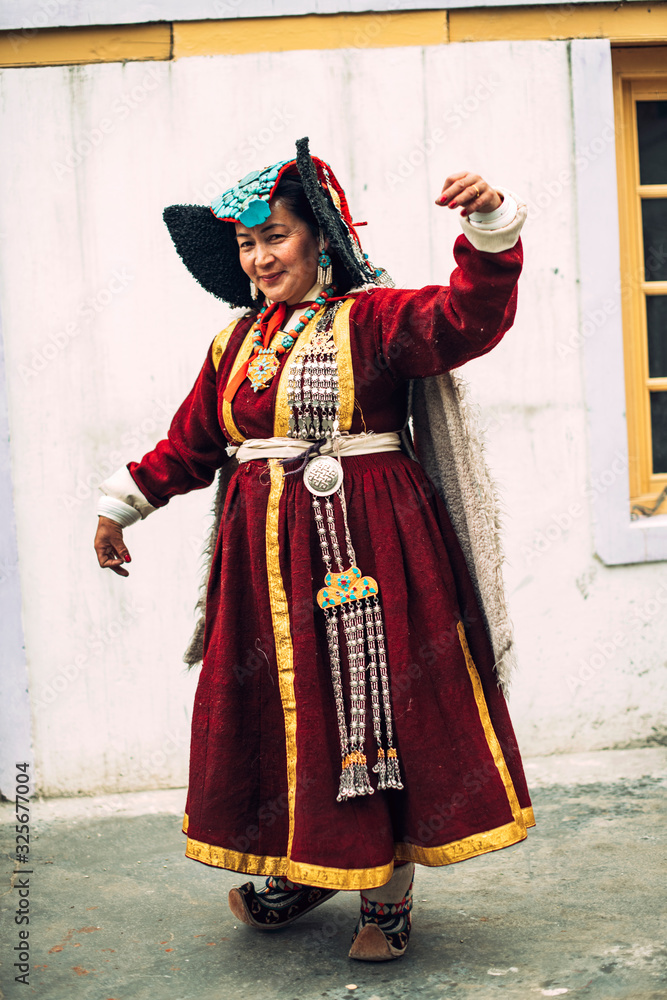 Woman dancing typical folkloric dances in traditional costume in Ladakh ...