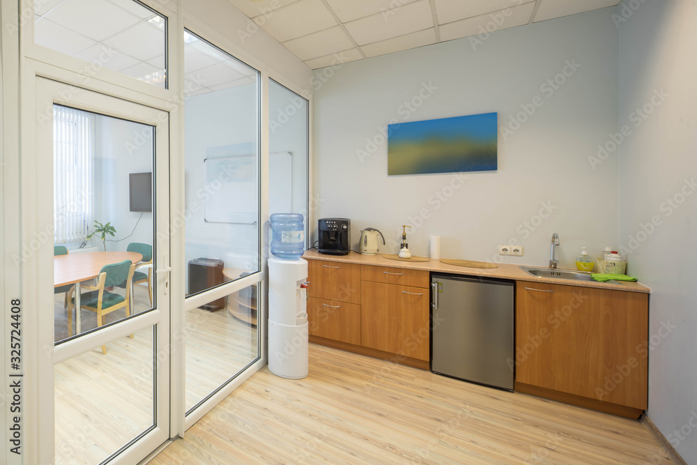 Modern interior of kitchen in office. Glass door and wall. Meeting room ...
