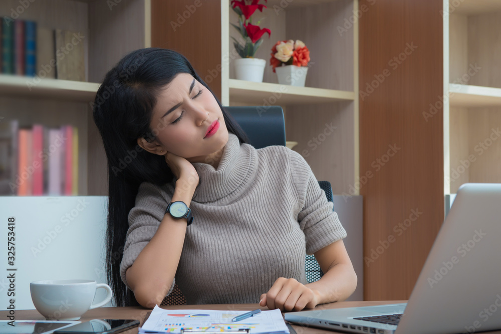 young businesswoman or secretary working with laptop and have a neck ...