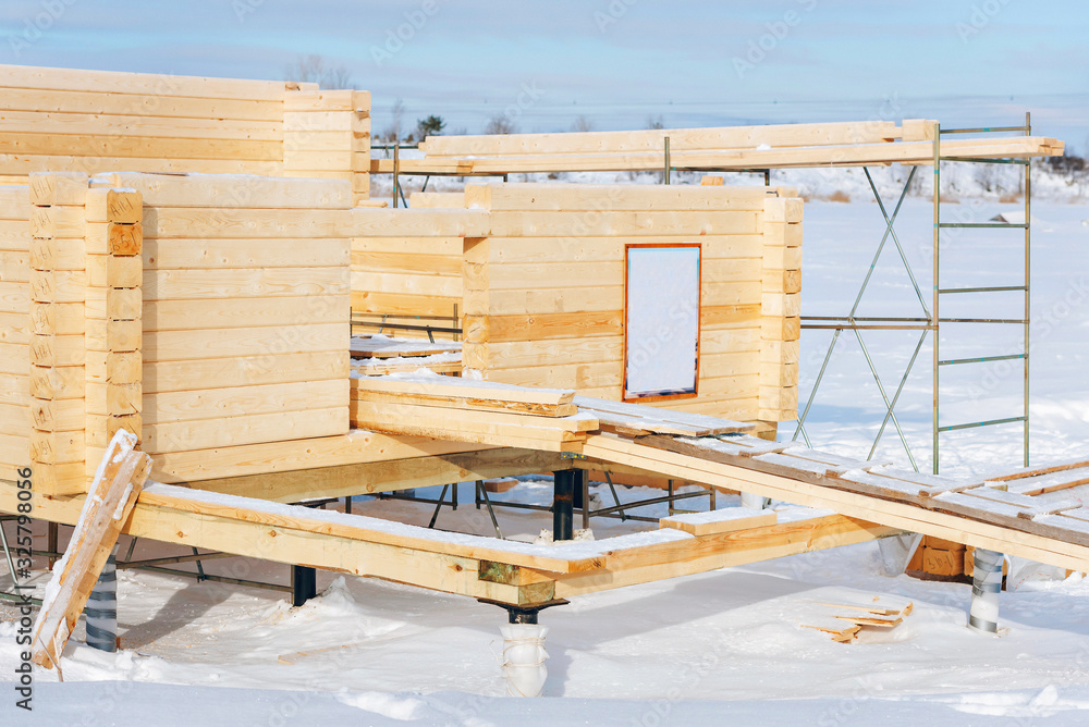 the process of building a wooden house from a square bar. unfinished ...
