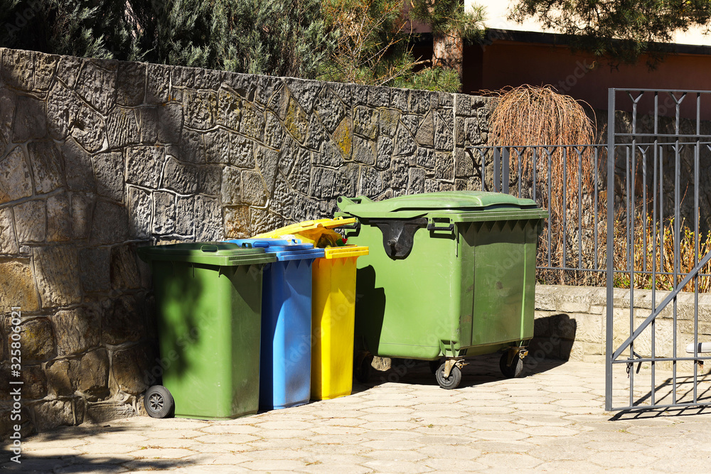 Four multicolored boxes for sorted garbage: green, blue and yellow ...