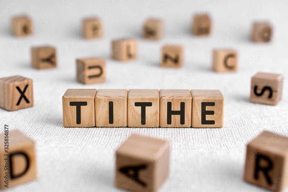 Tithe - words from wooden blocks with letters, one-tenth part tax to ...