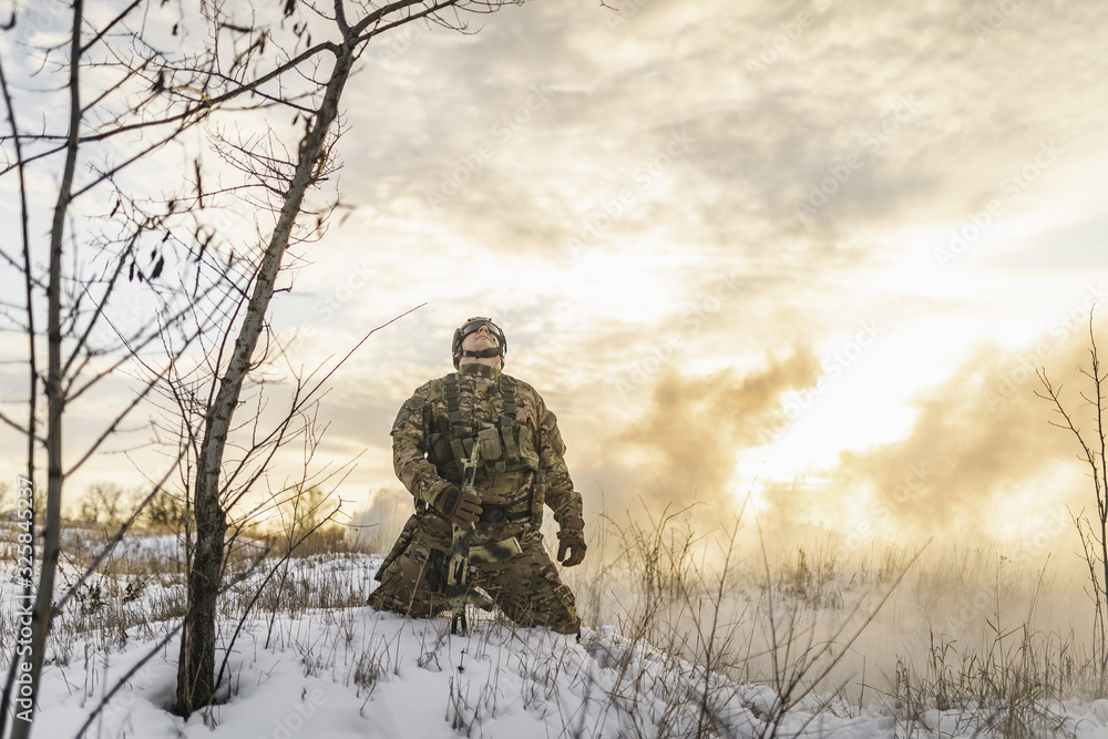 exhausted soldier man after battle fells to knees or kneeling in winter ...