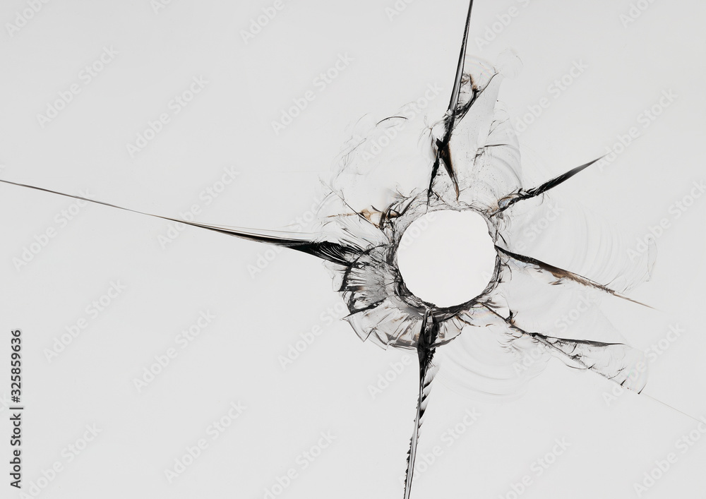 Broken glass. Cracked window. Bullet hole in window on white background ...
