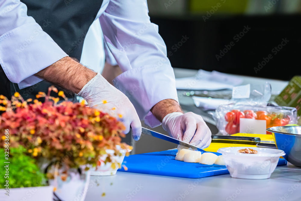 The chef's hands close up. Cooking seafood. Fish restaurant. The chef ...