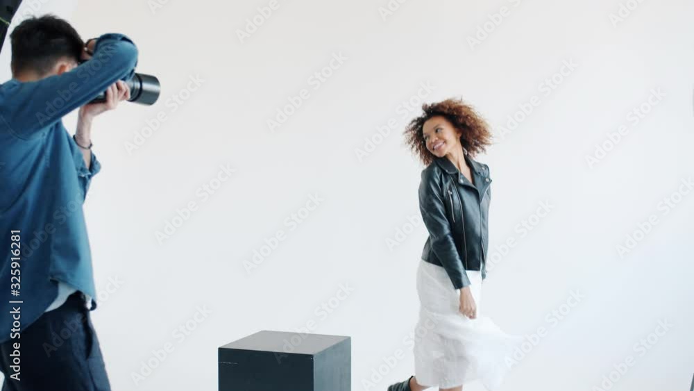 Vidéo Stock Smiling young mixed race model is posing on white ...