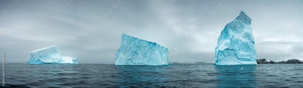 panorama with three giant icebergs in strait in Antarctica Stock Photo ...