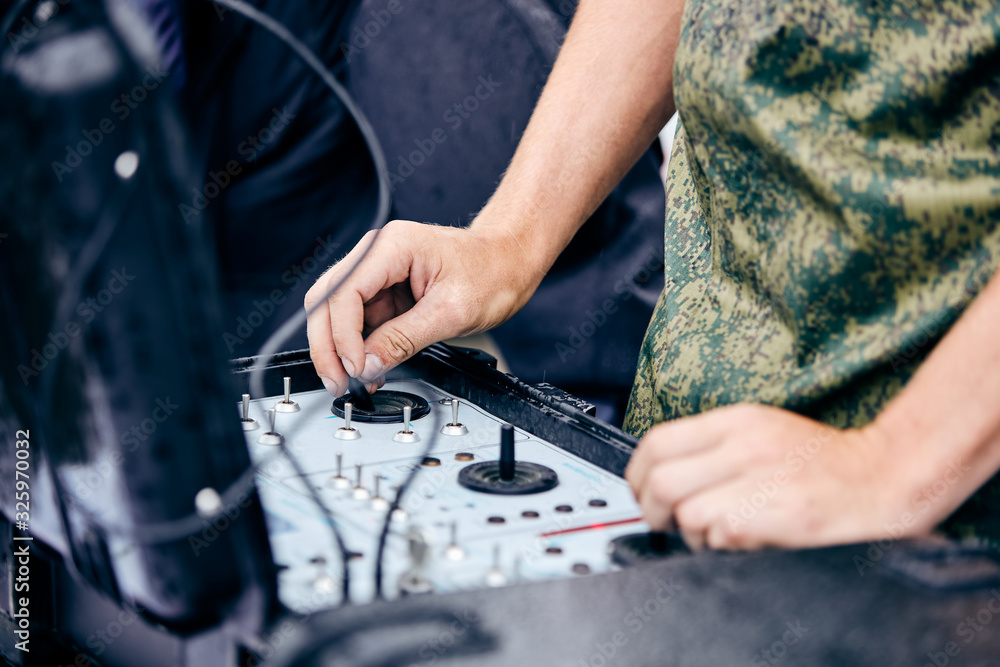 Military operator manages with the help of the remote control the ...